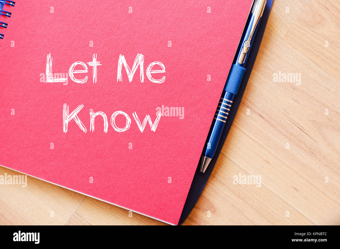 Let me know write on notebook Stock Photo - Alamy