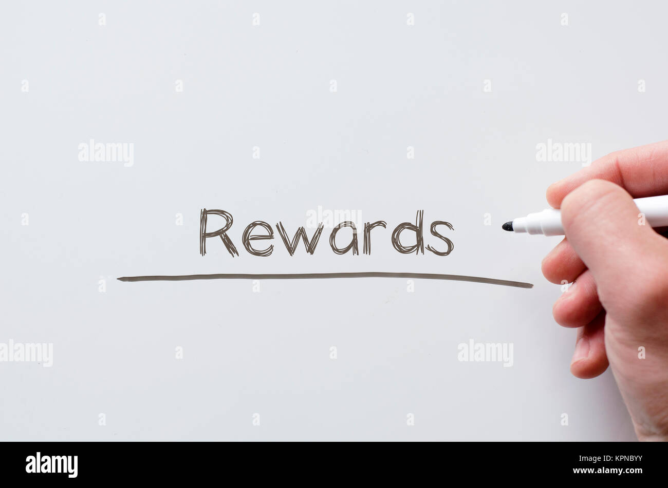 Rewards written on whiteboard Stock Photo - Alamy