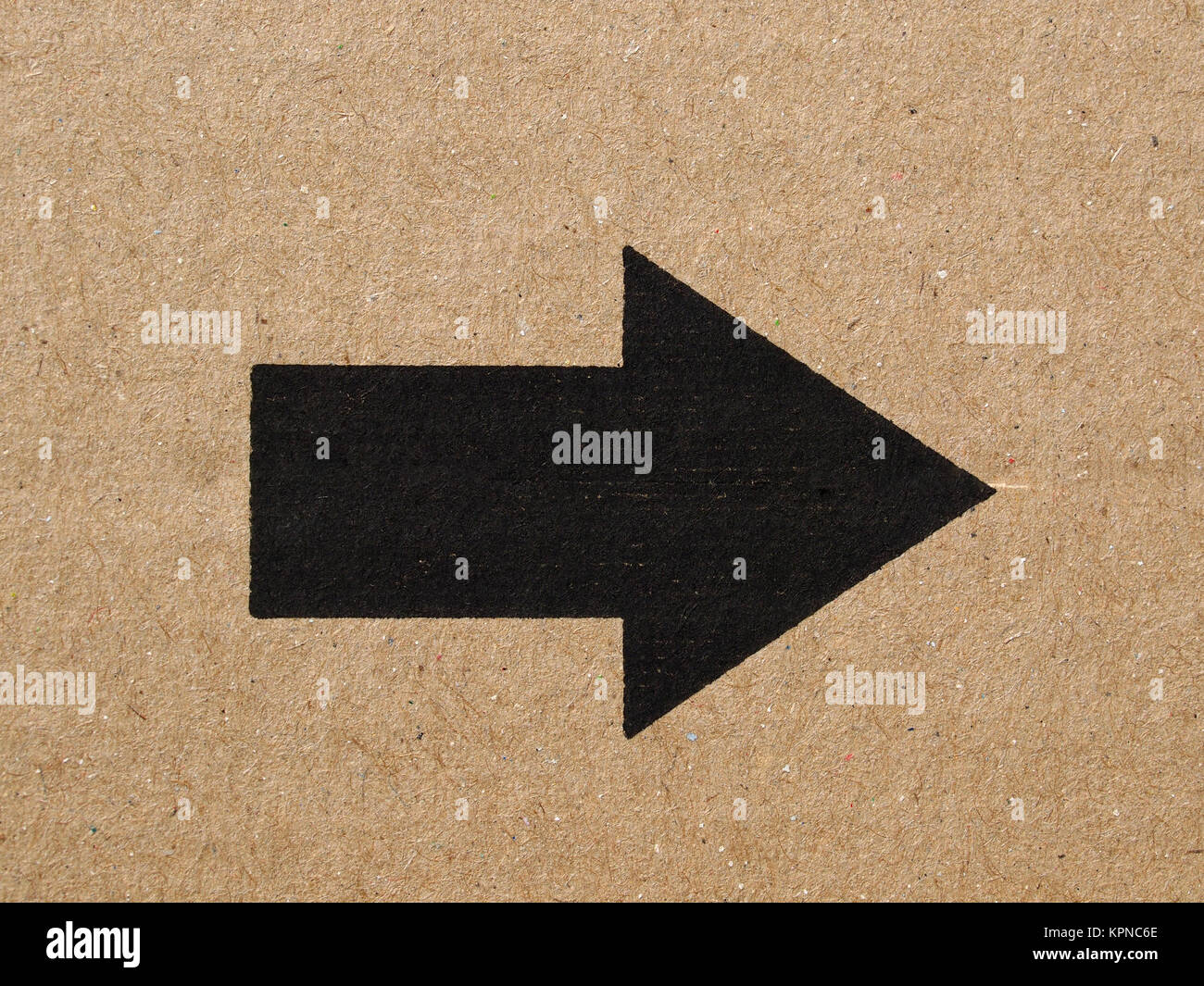 Black arrow on cardboard Stock Photo - Alamy