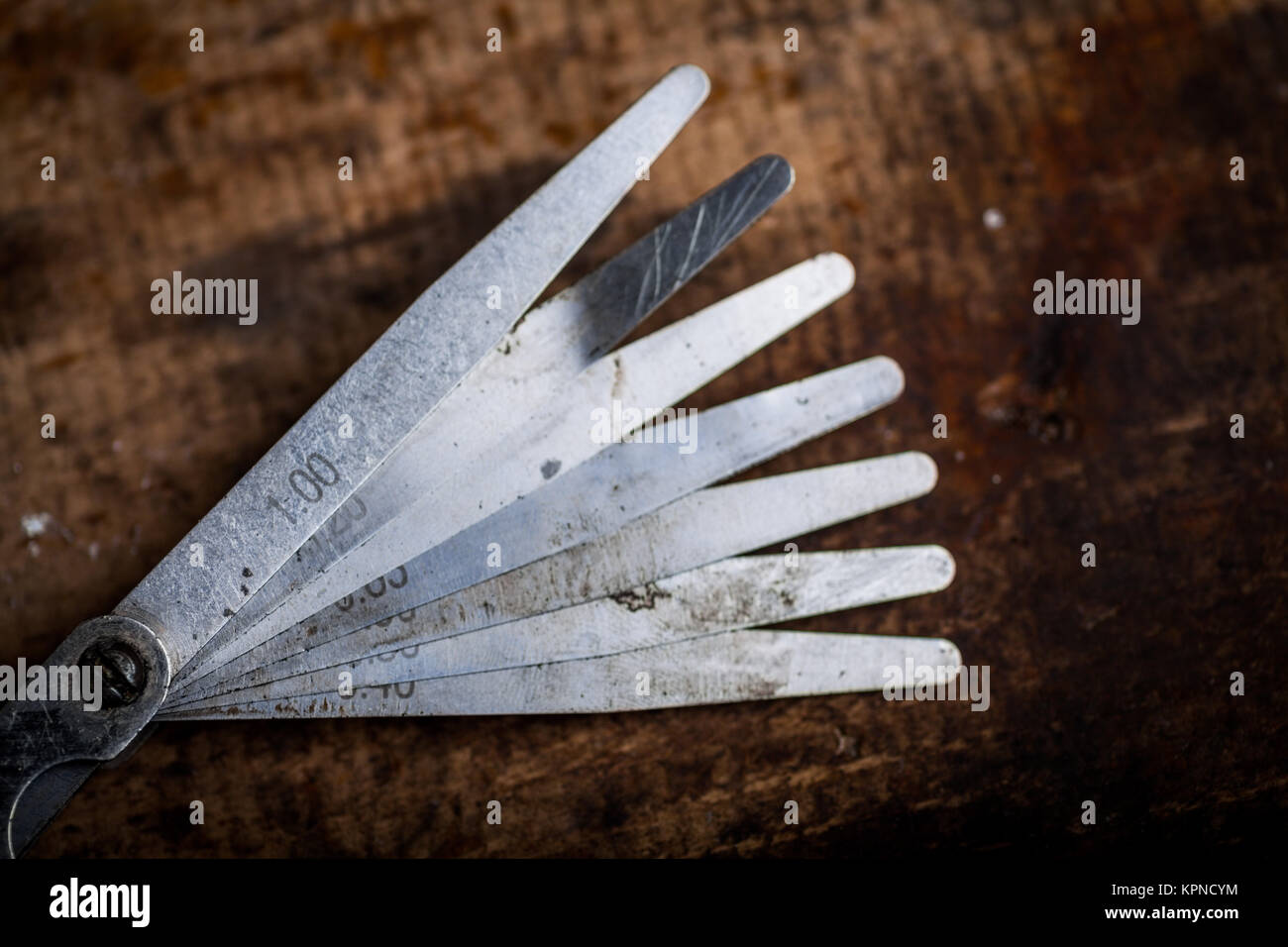 Valve clearance measuring tool on wooden plank Stock Photo - Alamy