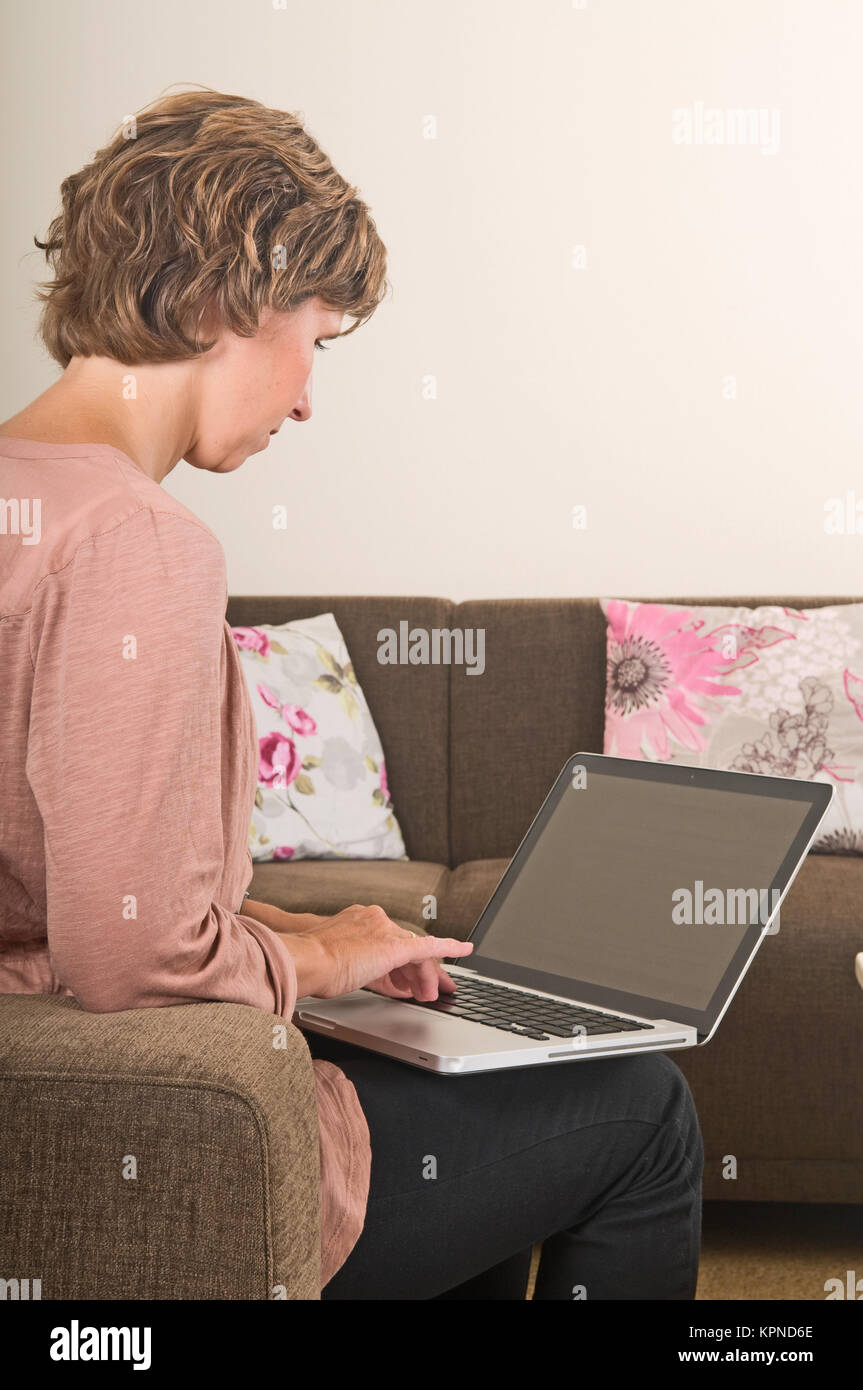 Woman working on a laptop Stock Photo - Alamy