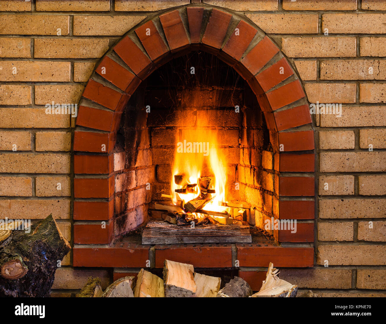 open fire in indoor brick fireplace Stock Photo - Alamy