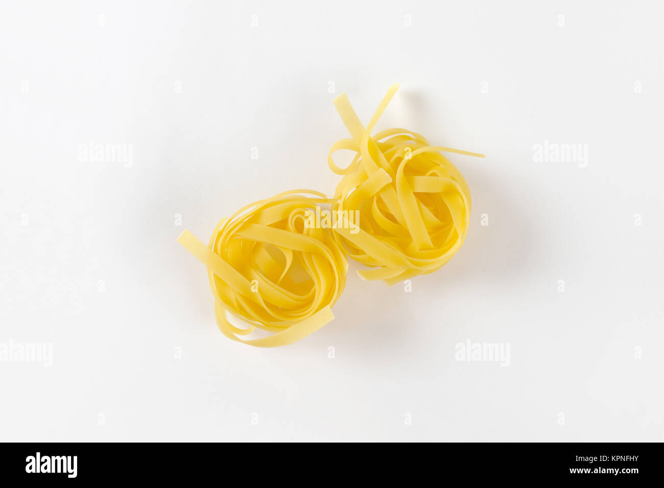 Dried tagliatelle pasta nests hi-res stock photography and images - Alamy