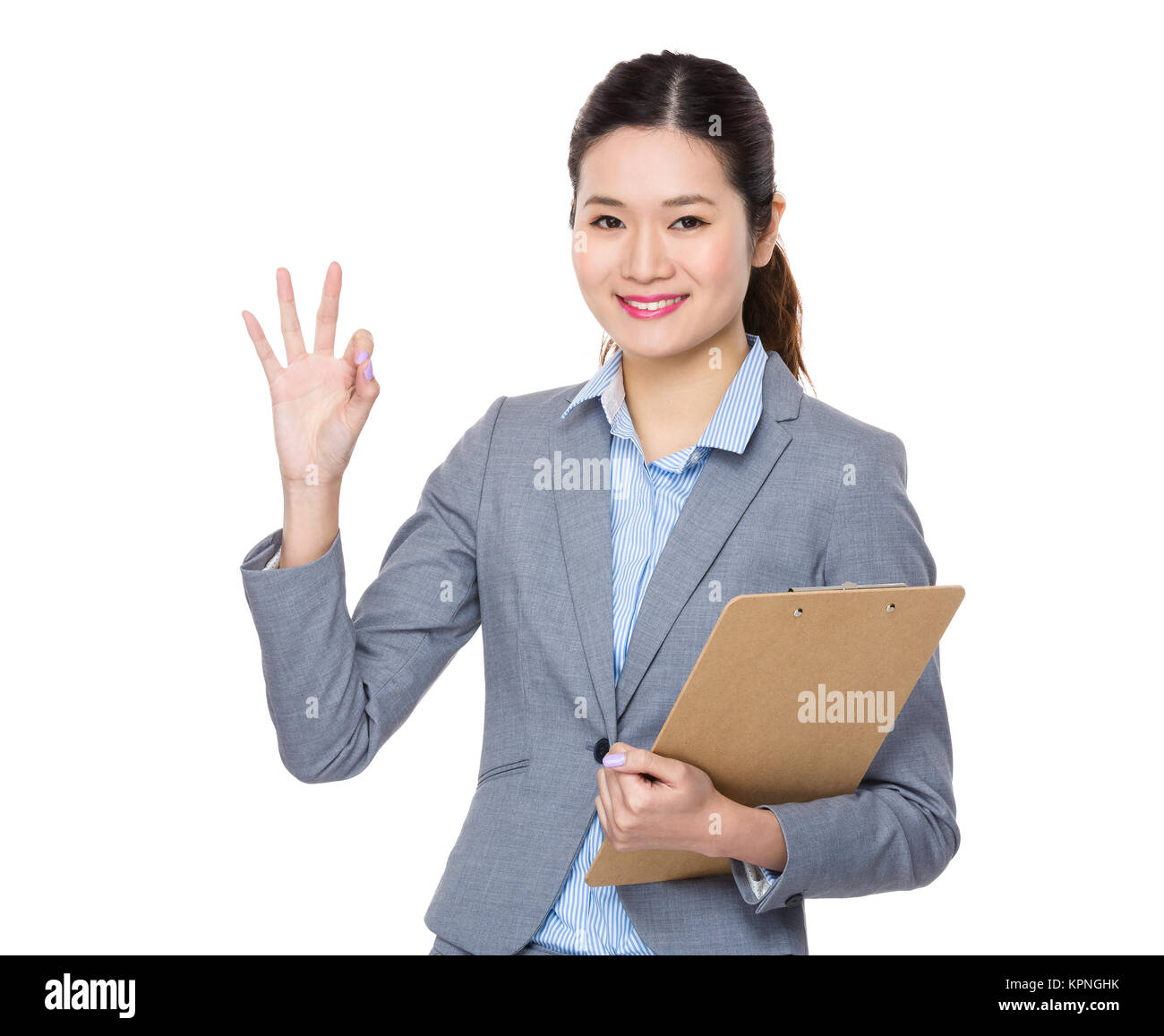 Businesswoman hold with clipboard and ok sign gesture Stock Photo - Alamy