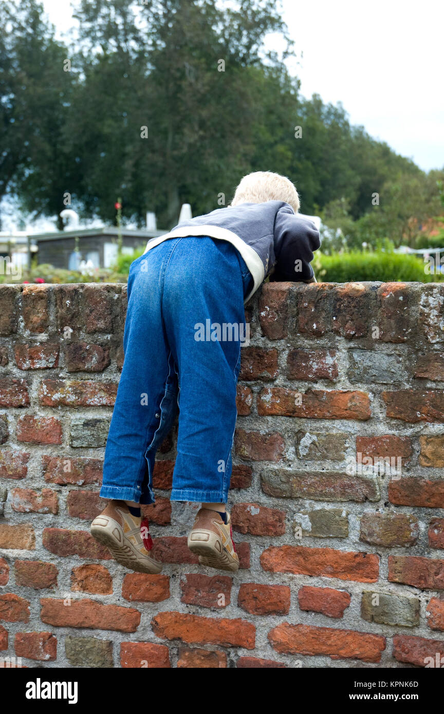 Boy On A Wall Stock Photo - Alamy
