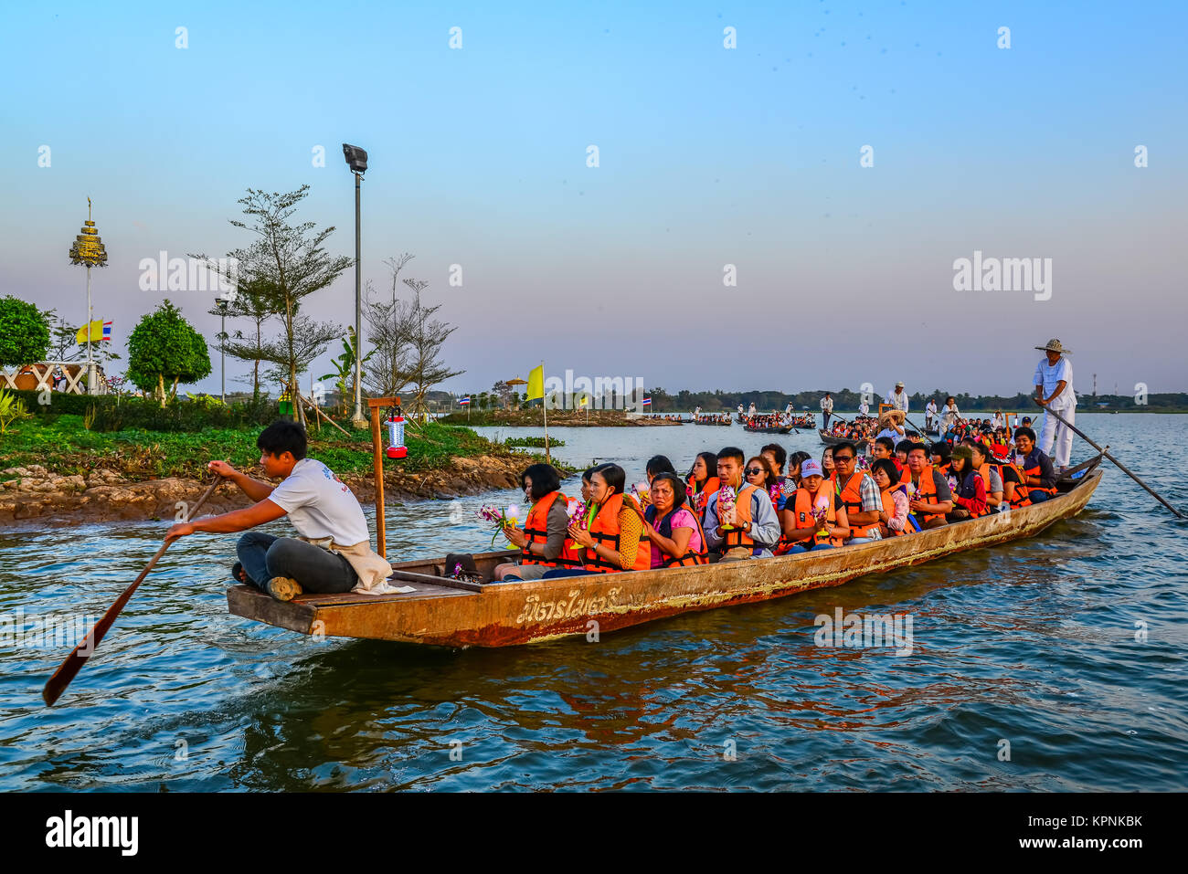 PAYAO, THAILAND - FEBRUARY 14, 2014: Buddhists on boats with candles ...