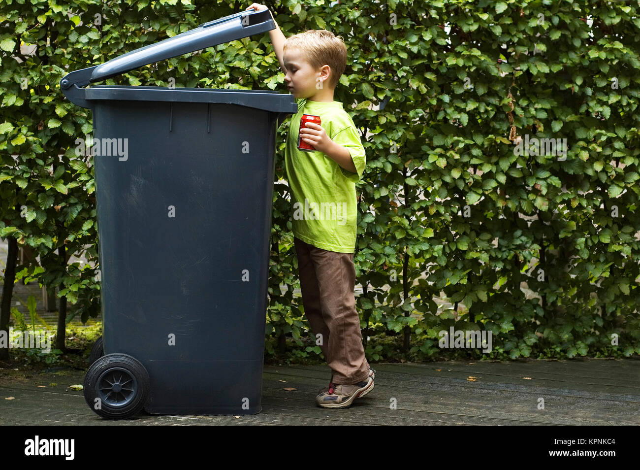 Boy Trashing A Can Stock Photo - Alamy