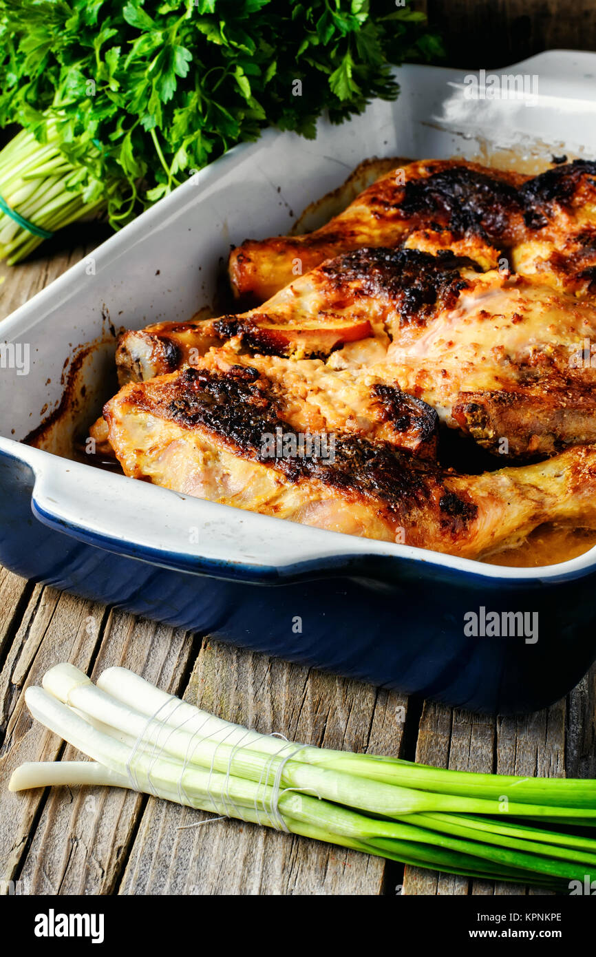 Baked chicken in a porcelain form on a rustic recipe Stock Photo - Alamy