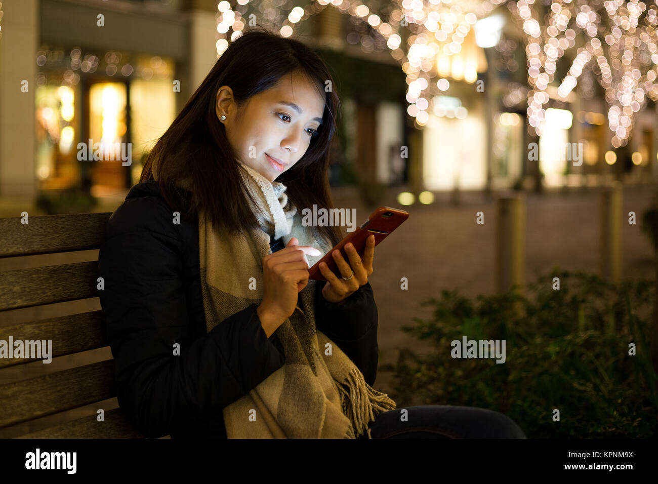 Woman using cellphone at night Stock Photo - Alamy
