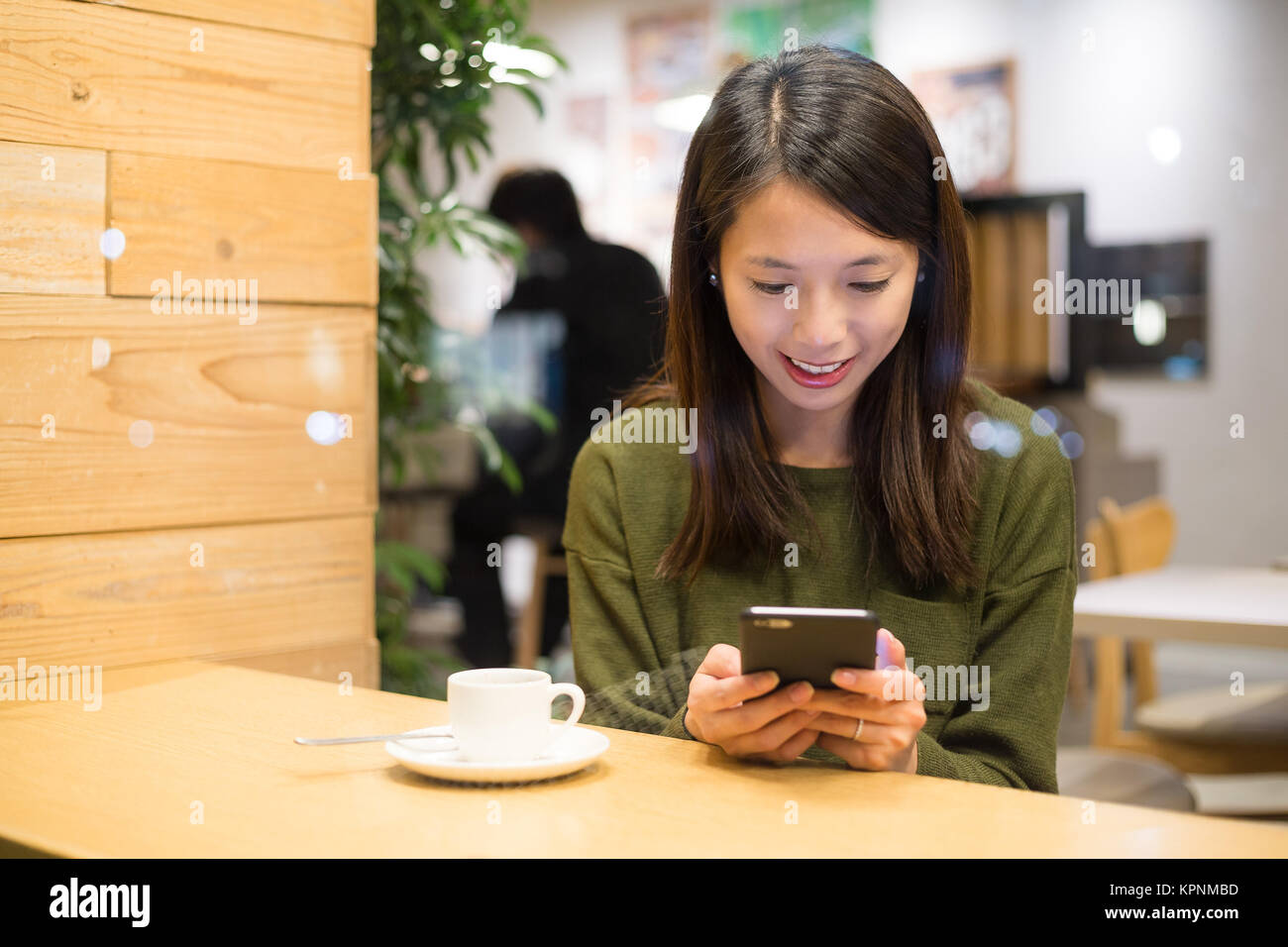 Woman use of mobile phone inside coffee shop Stock Photo - Alamy