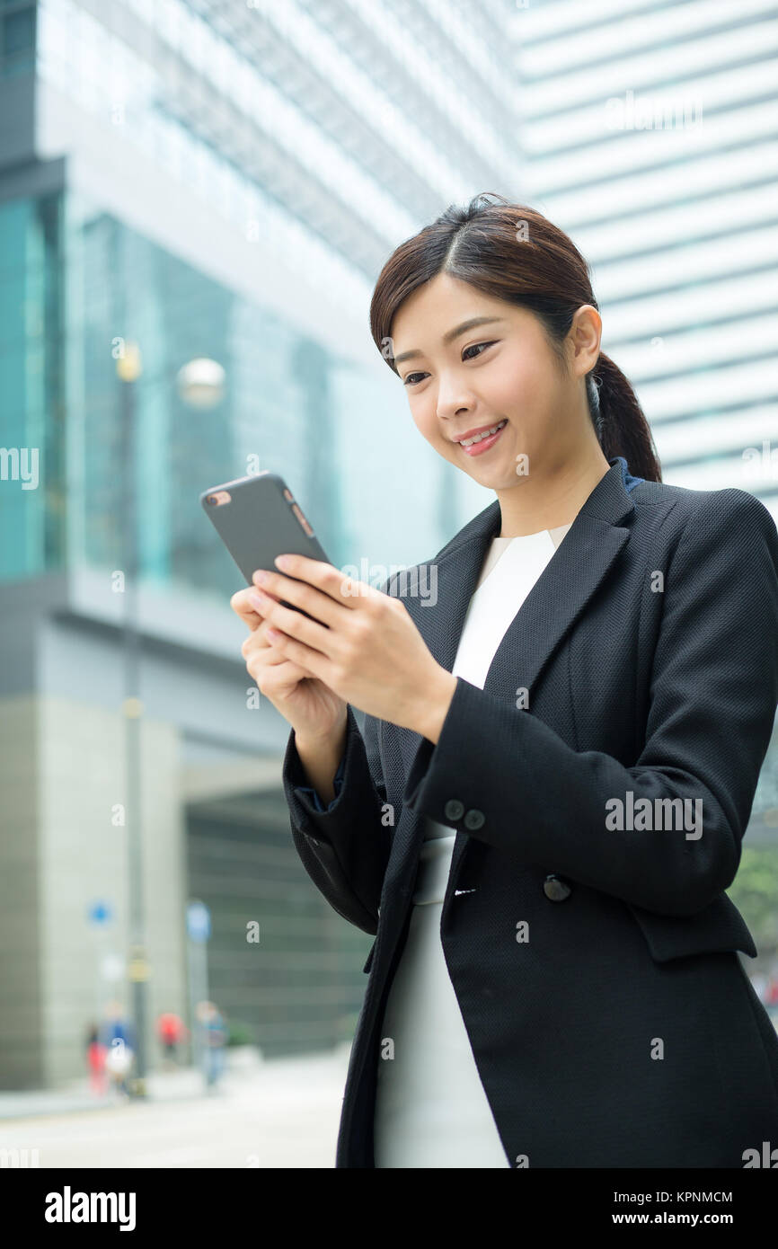 Businesswoman use of mobile phone Stock Photo - Alamy
