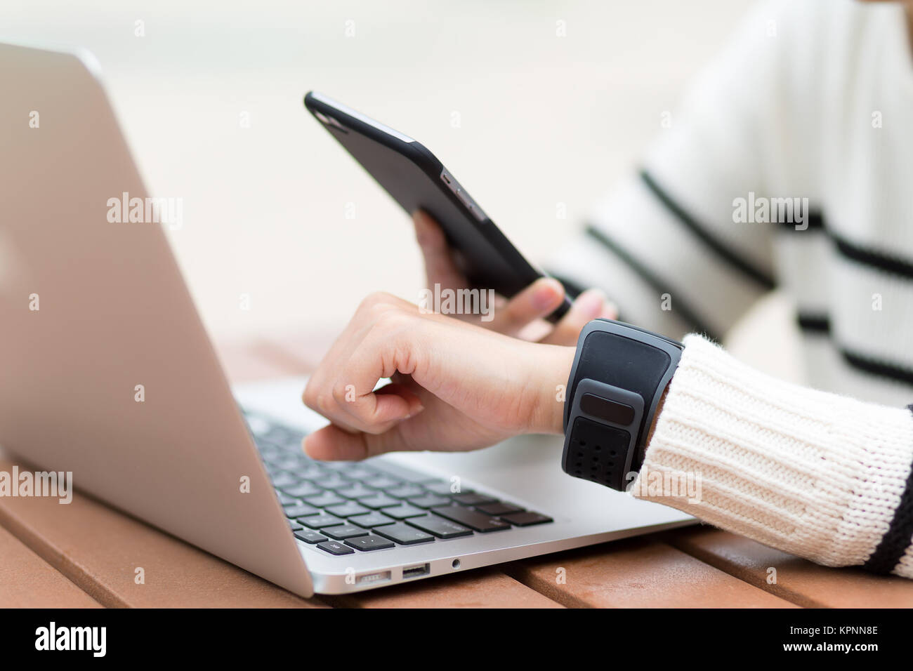 Woman connect the smart watch and mobile phone Stock Photo - Alamy