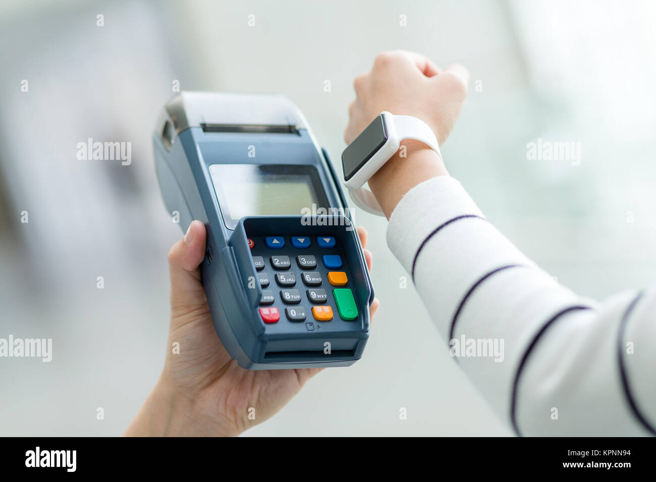 Woman using Smartwatch pay by NFC Stock Photo - Alamy