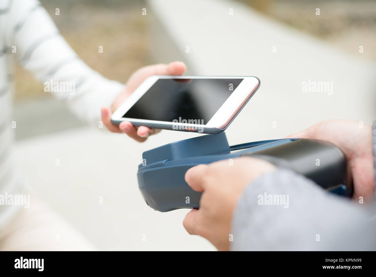 Customer using mobile phone to pay Stock Photo - Alamy