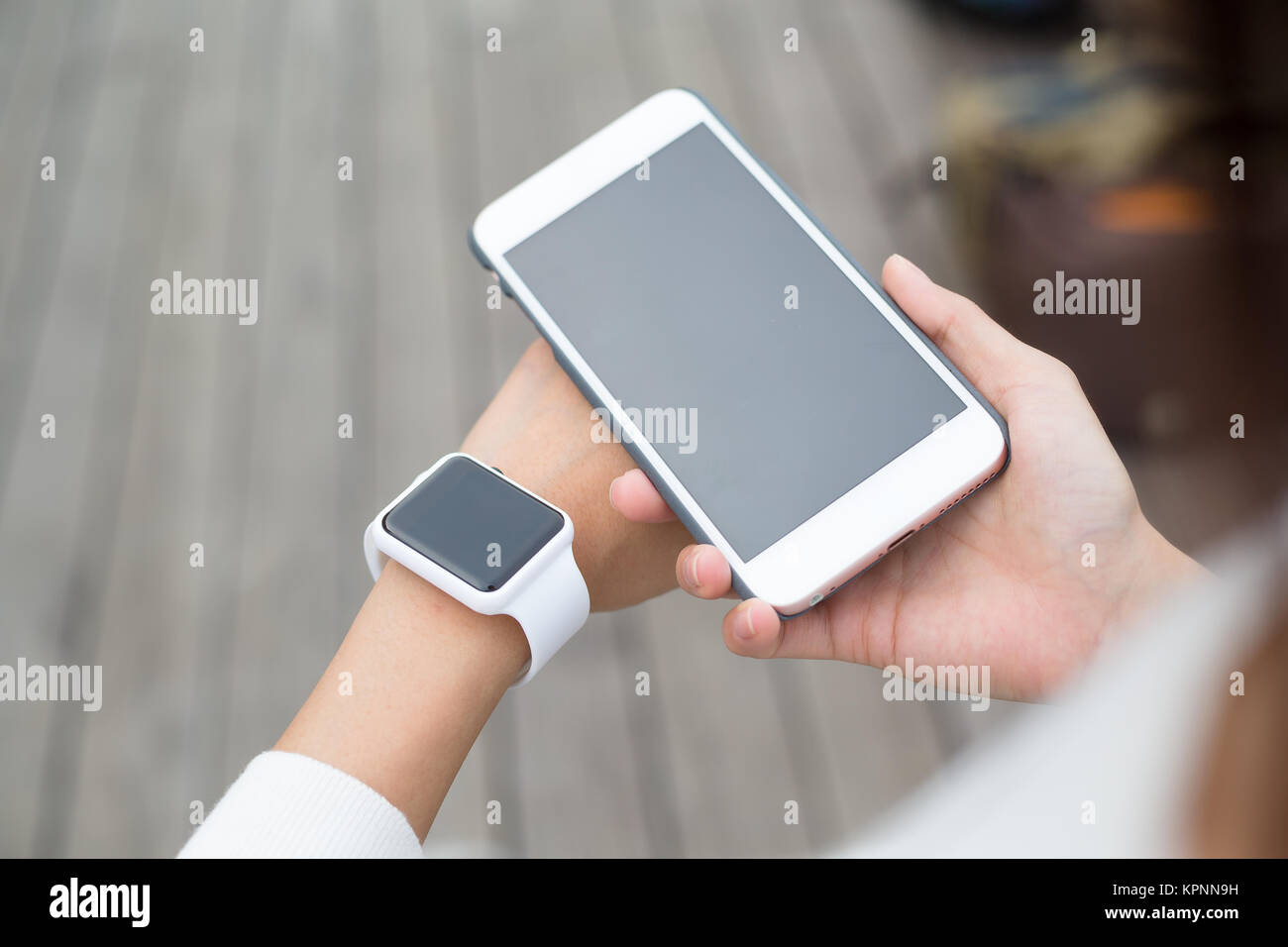 Woman use of watch and phone Stock Photo - Alamy