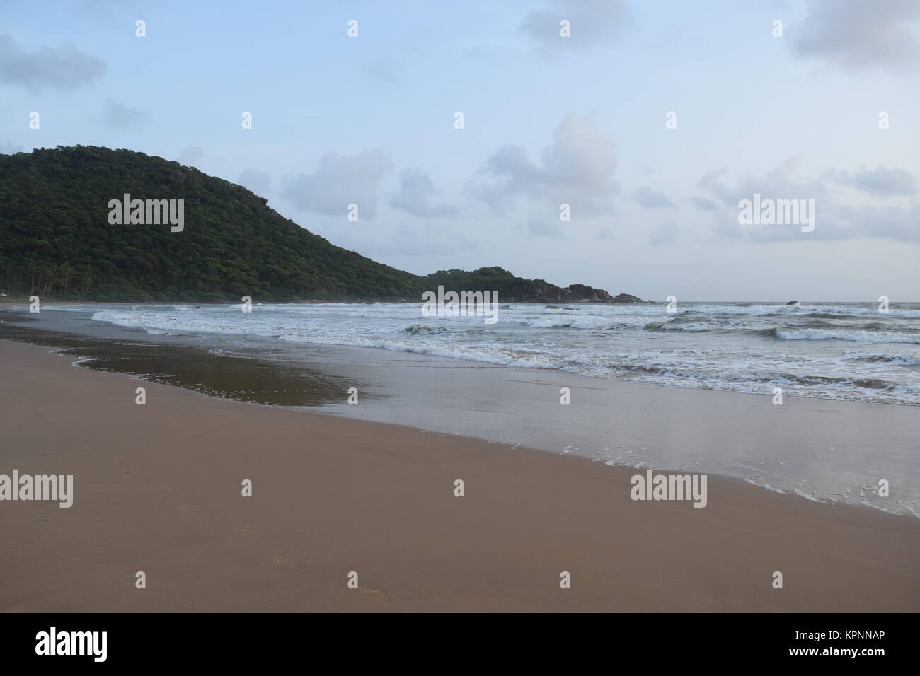 Nice sandy beach view with clouds in sky. Cloudy day with calm sandy ...