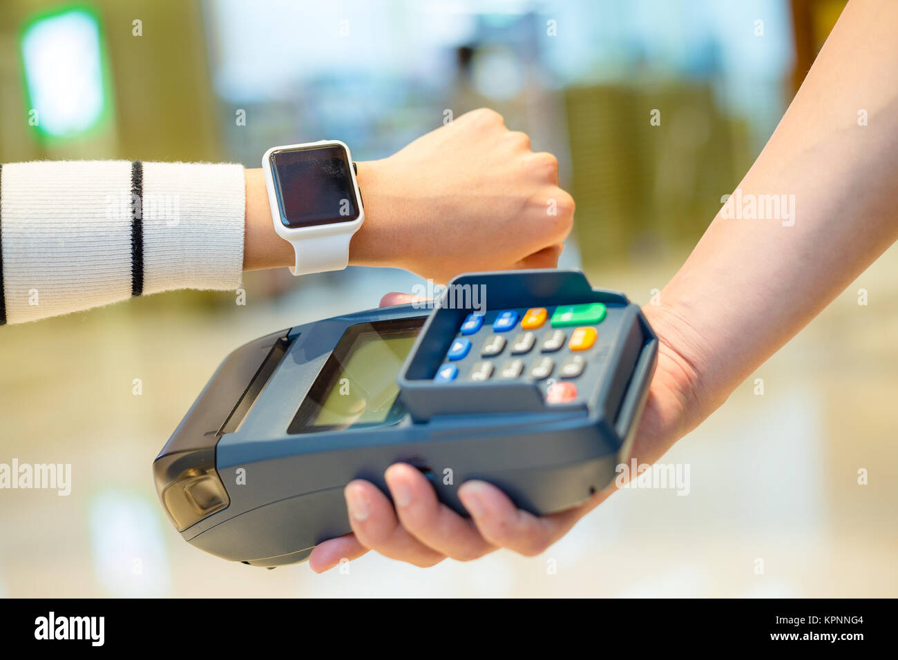 Woman paying with smartwatch by NFC Stock Photo - Alamy