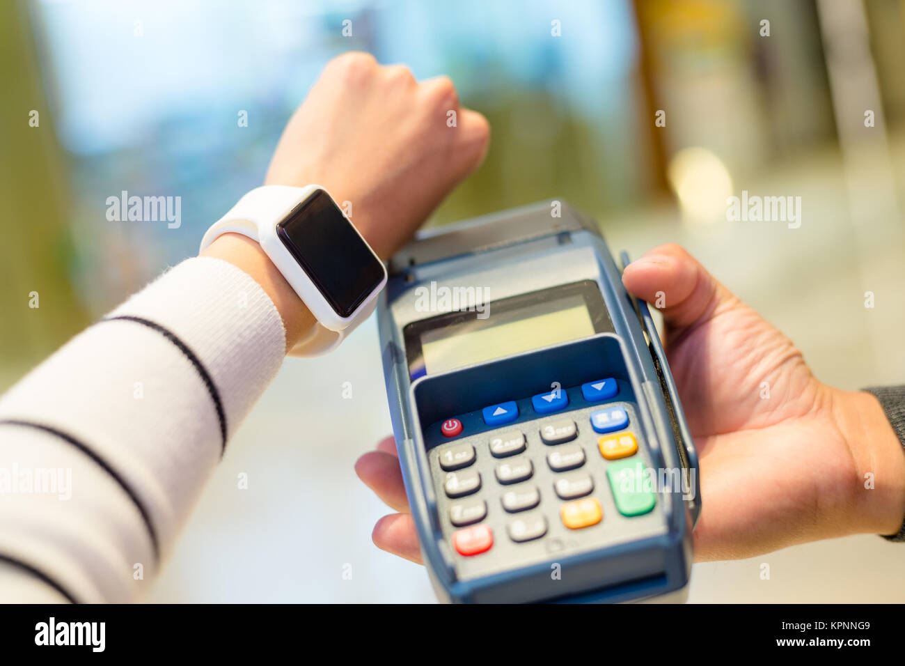 Woman using smartwatch for paying with NFC technology Stock Photo - Alamy
