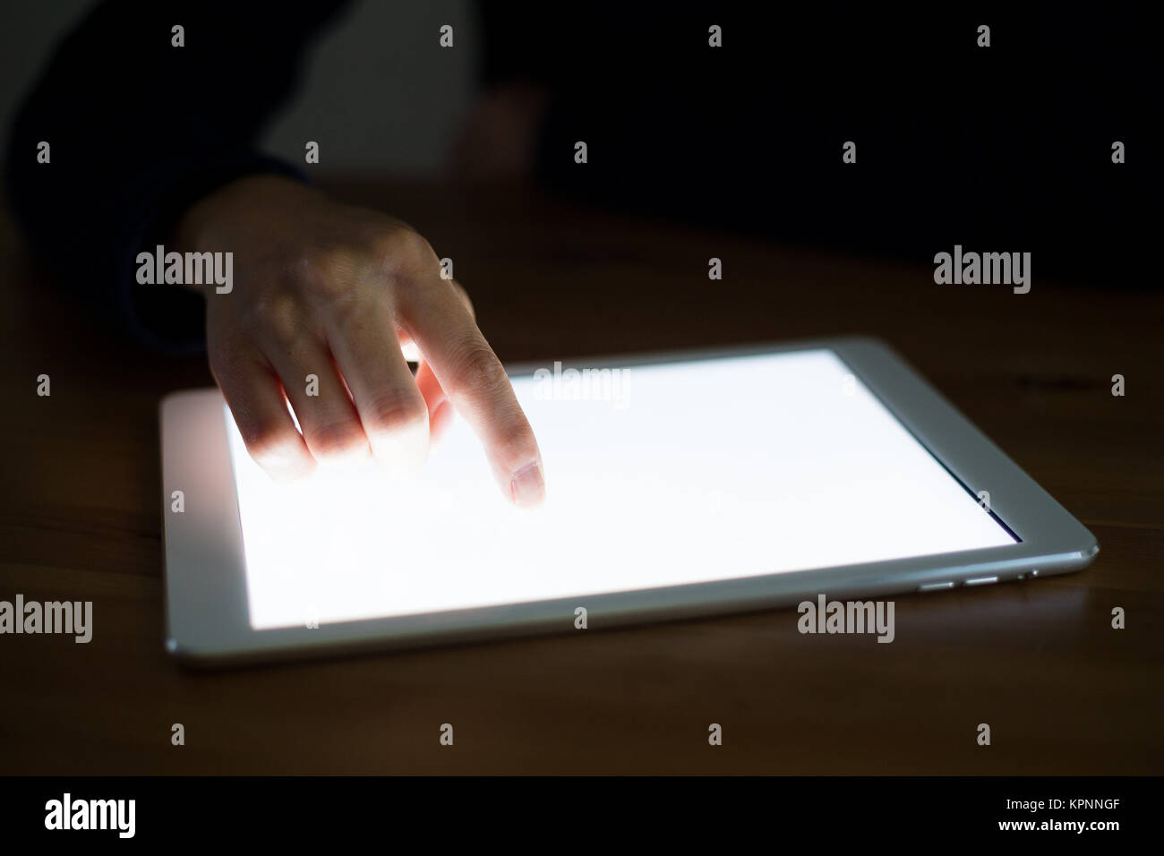 Woman finger point to screen of tablet pc at night Stock Photo - Alamy