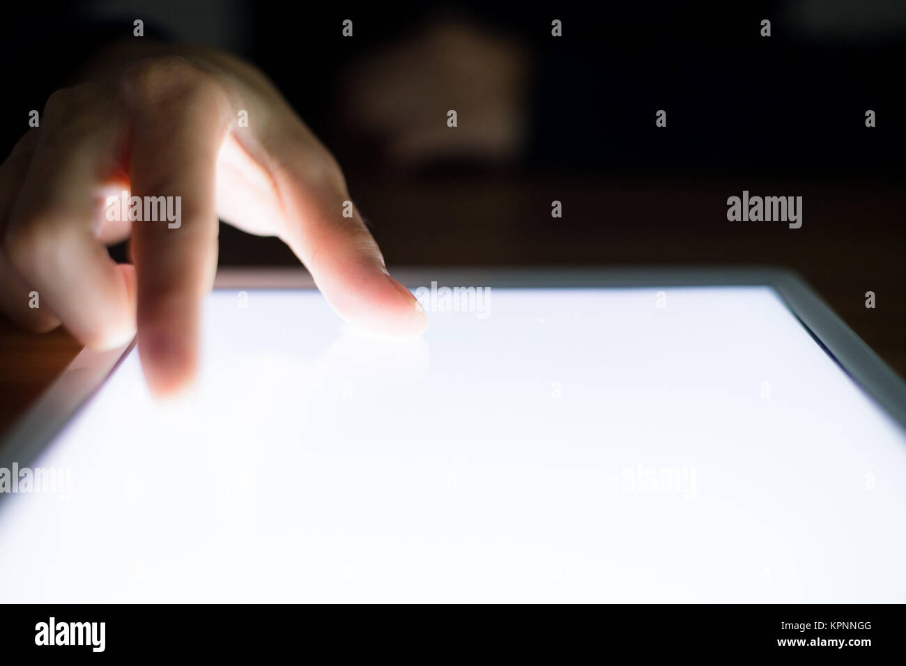 Woman using finger on screen of tablet pc Stock Photo - Alamy