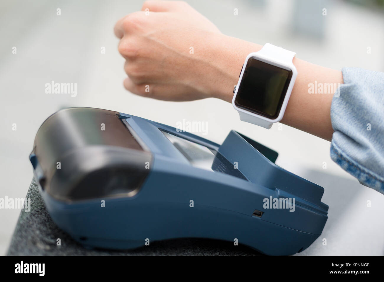 Woman using smart watch pay on pos machine Stock Photo - Alamy