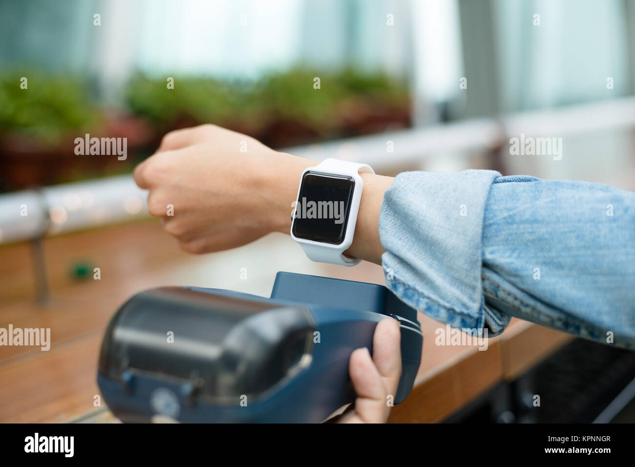 Customer using wearable watch to pay Stock Photo - Alamy