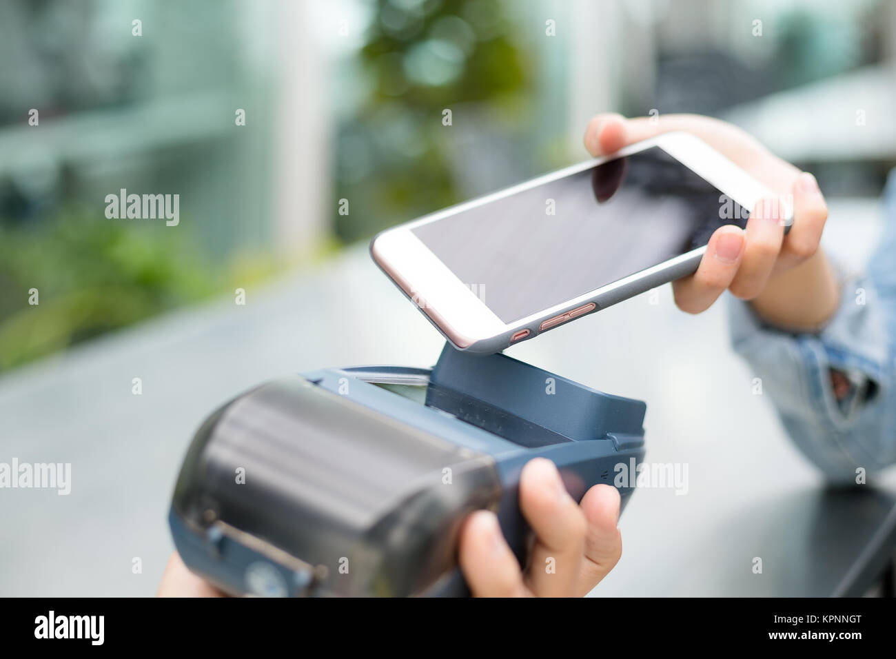 Woman using mobile phone for pay by the bill Stock Photo - Alamy