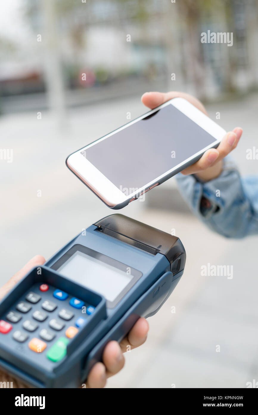 Customer using mobile phone to checkout Stock Photo - Alamy