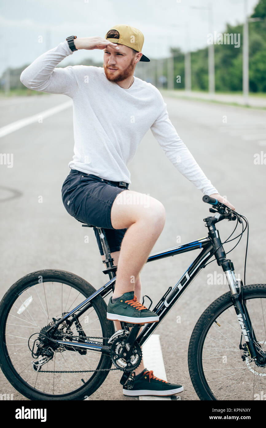 Man riding a bicycle on a road Stock Photo - Alamy