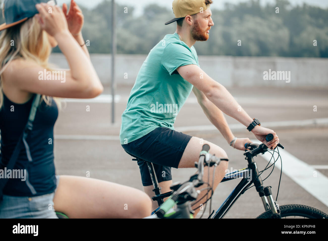 Side view of a young couple on cycle ride in countryside Stock Photo ...