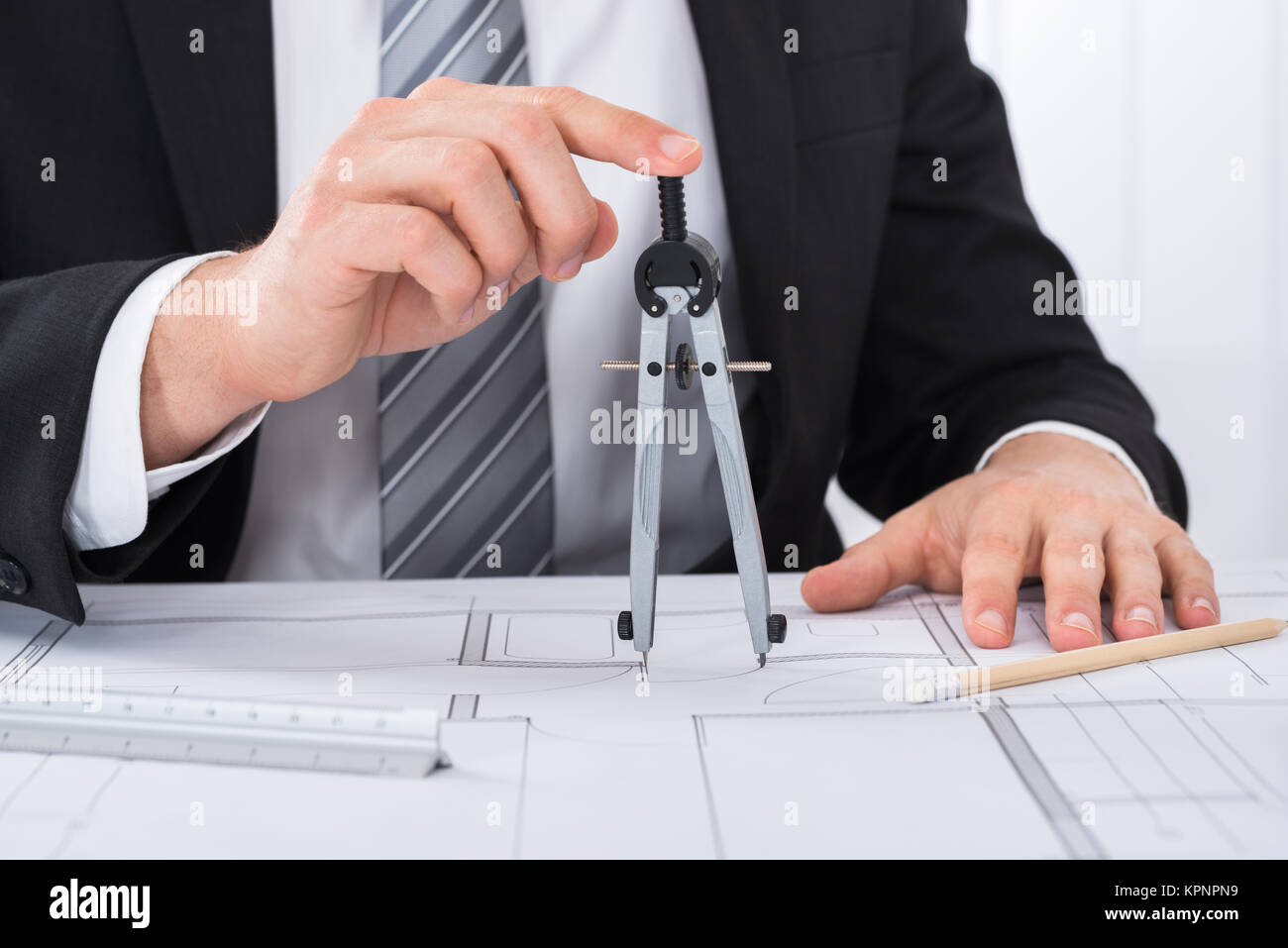 Male Architect Hands Holding Compass On Blueprint Stock Photo - Alamy