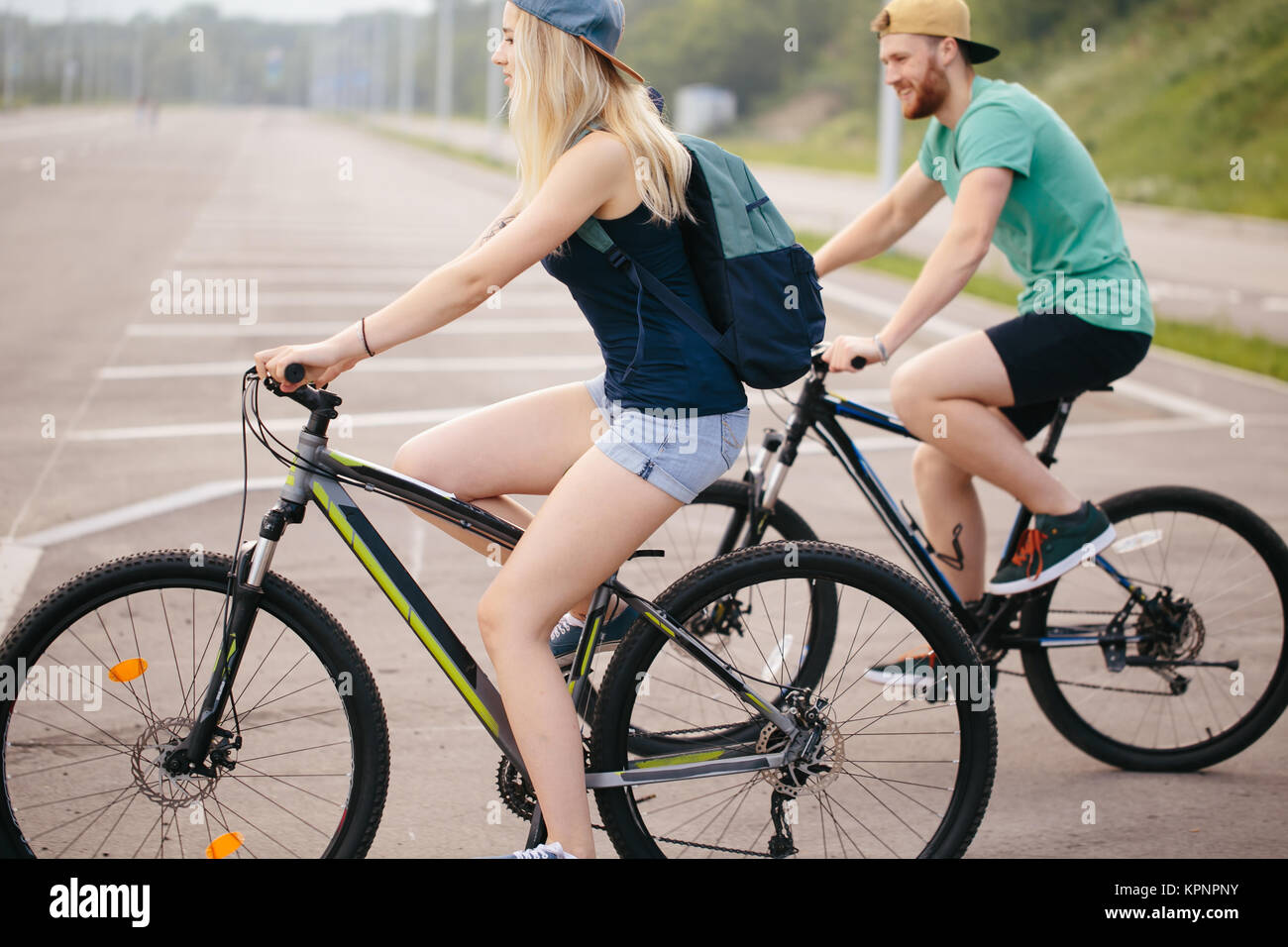 Side view of a young couple on cycle ride in countryside Stock Photo ...