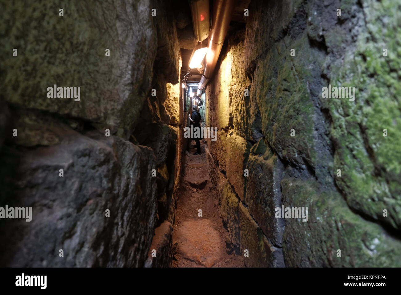 A visitor walking through the narrow path inside the ancient drainage ...