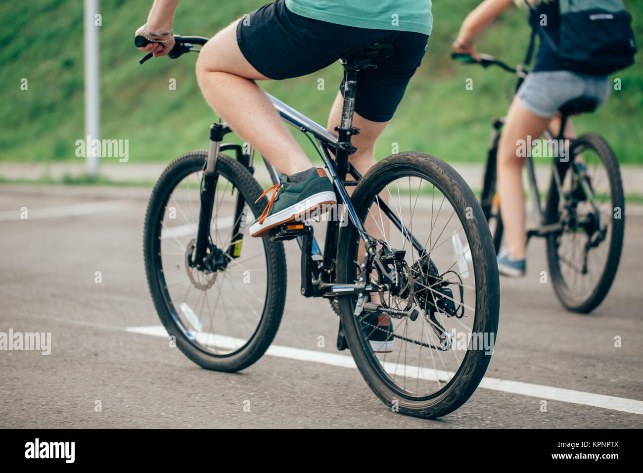 Young sporty couple riding on bicycle. Rear view Stock Photo - Alamy
