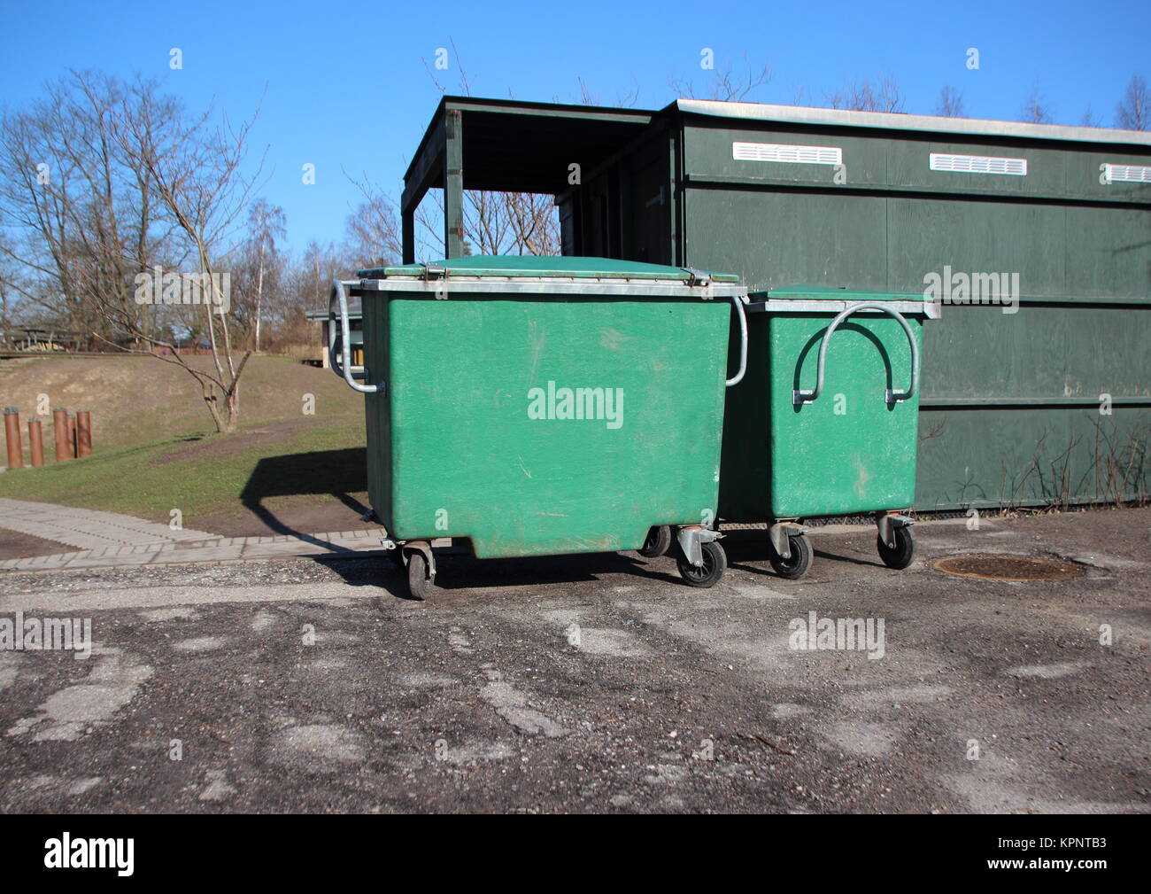 Green Garbage Containers on Asphalt Parking place Stock Photo - Alamy