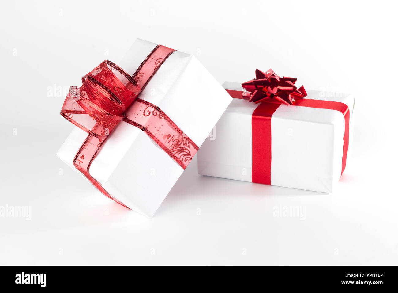 White presents with red ribbons and bows, isolated Stock Photo - Alamy