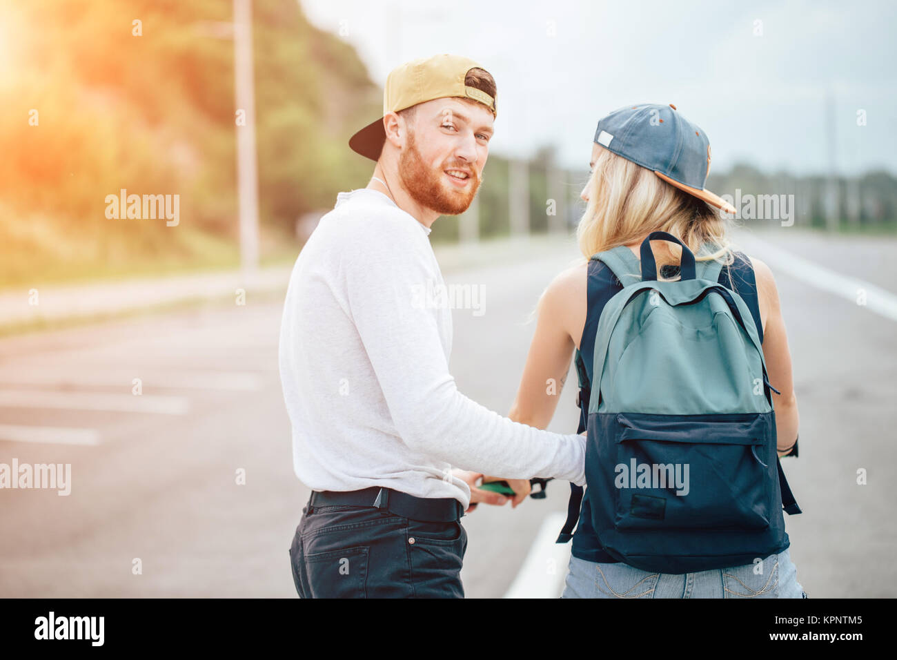 girl on bike, guy runs. boy teaches girl to ride a bike. Morning Meadow ...