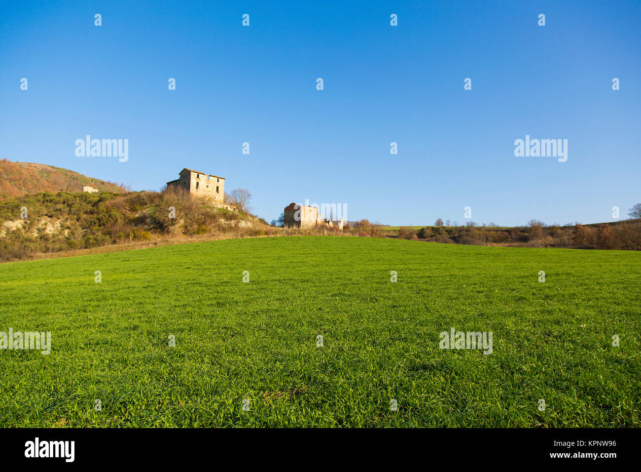Panoramic view of a field for the agriculture with an old farm in the ...
