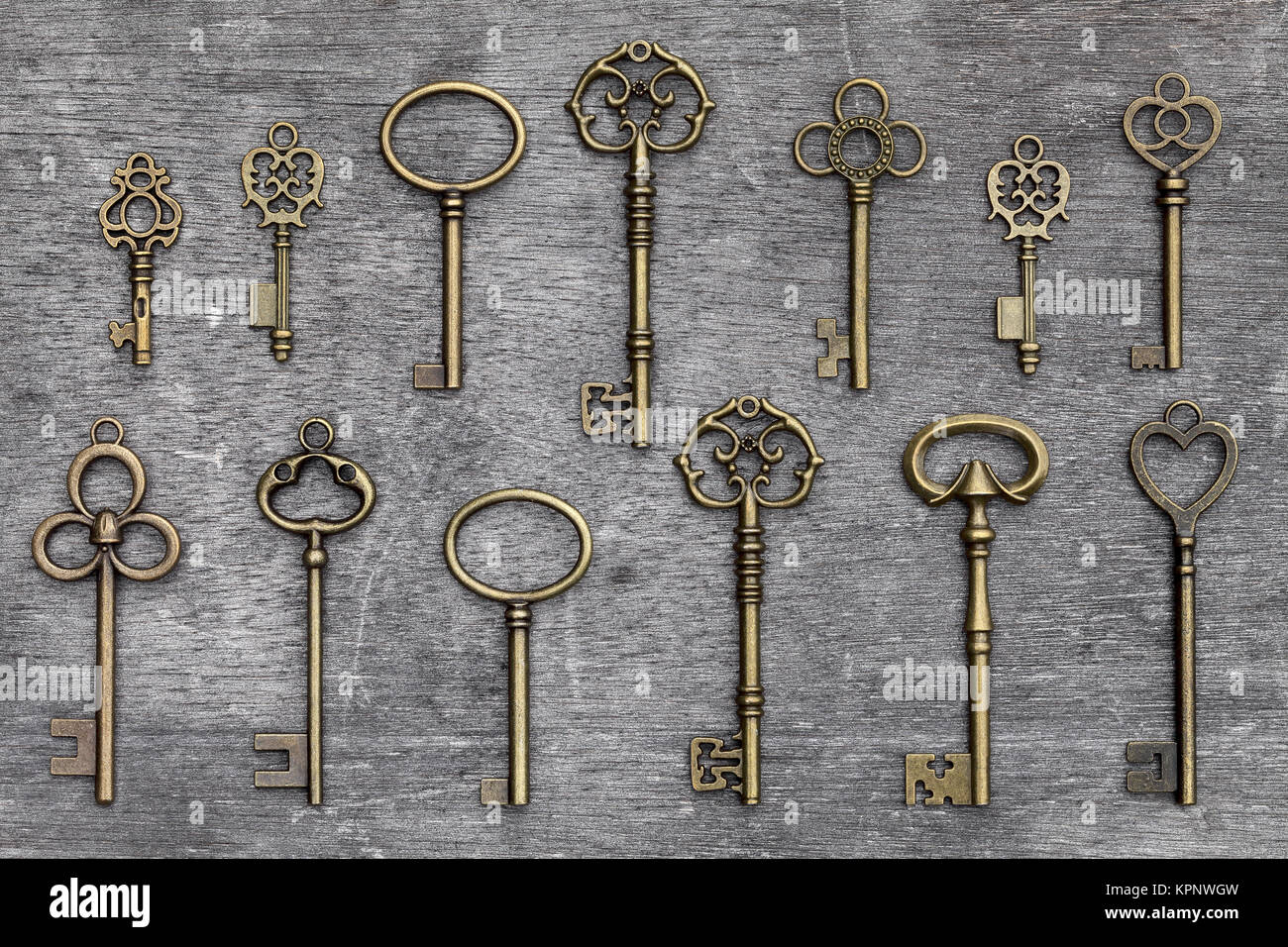 row of antique golden keys on a grunge wooden background Stock Photo ...