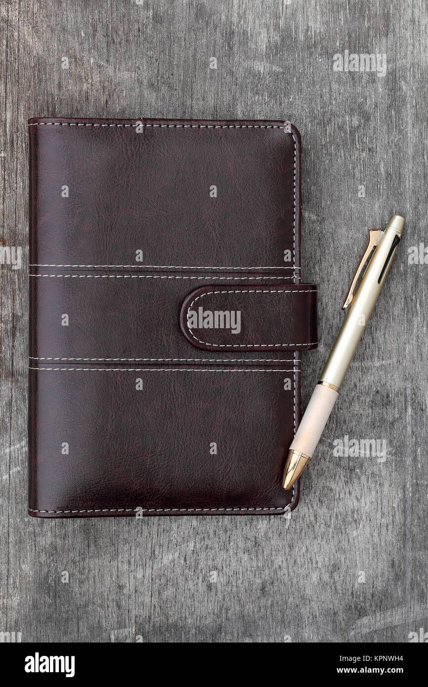 brown leather notebook and ballpoint pen Stock Photo - Alamy