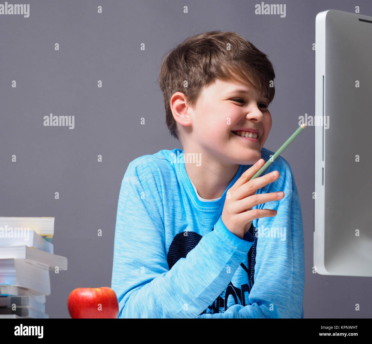 Young happy boy learning on a computer at home Stock Photo - Alamy