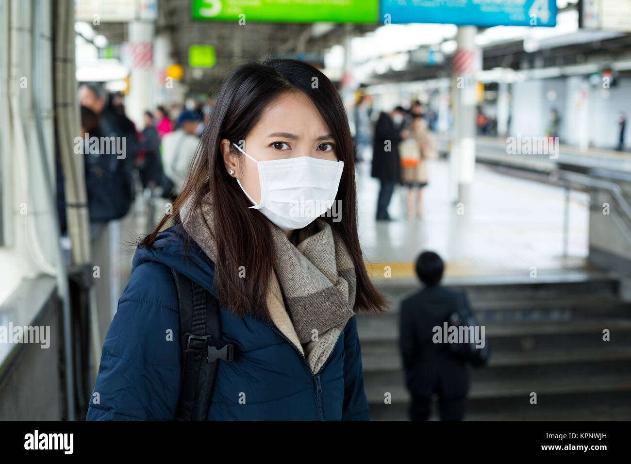 Woman wear face mask in train station Stock Photo - Alamy