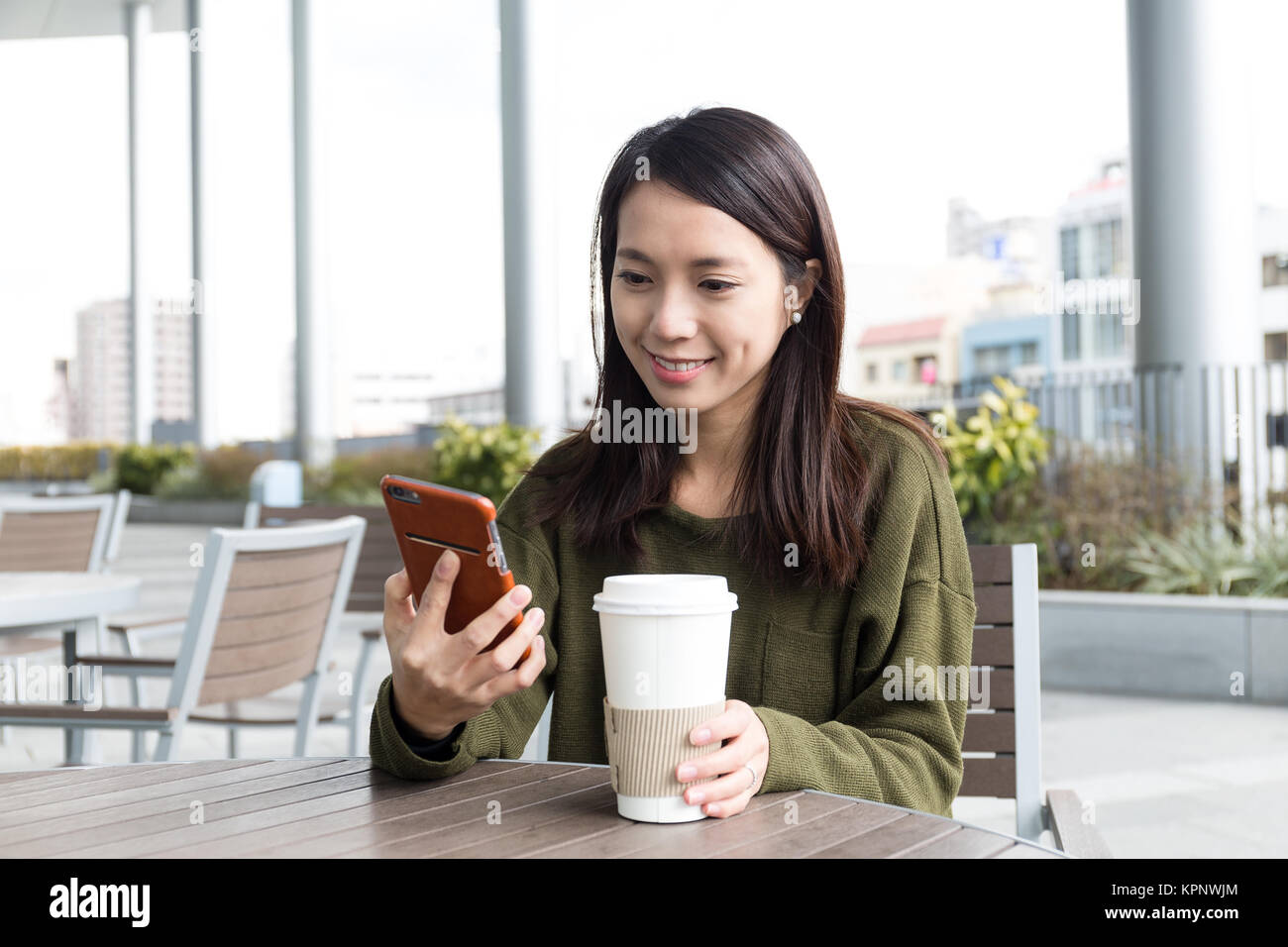 Woman use of mobile phone in coffee shop Stock Photo - Alamy