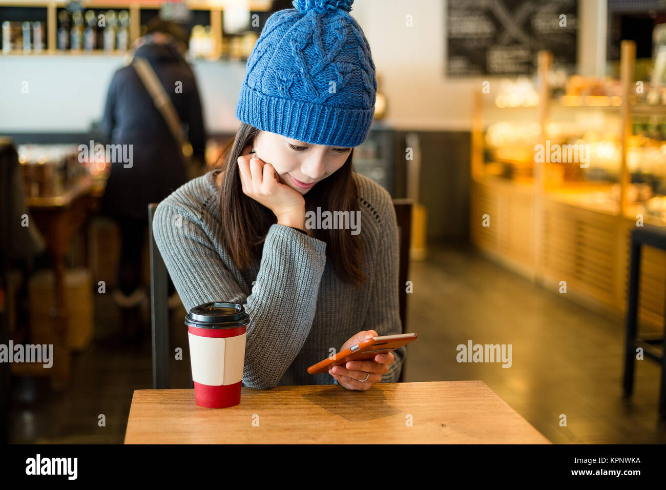 Woman use of mobile phone in coffee shop Stock Photo - Alamy