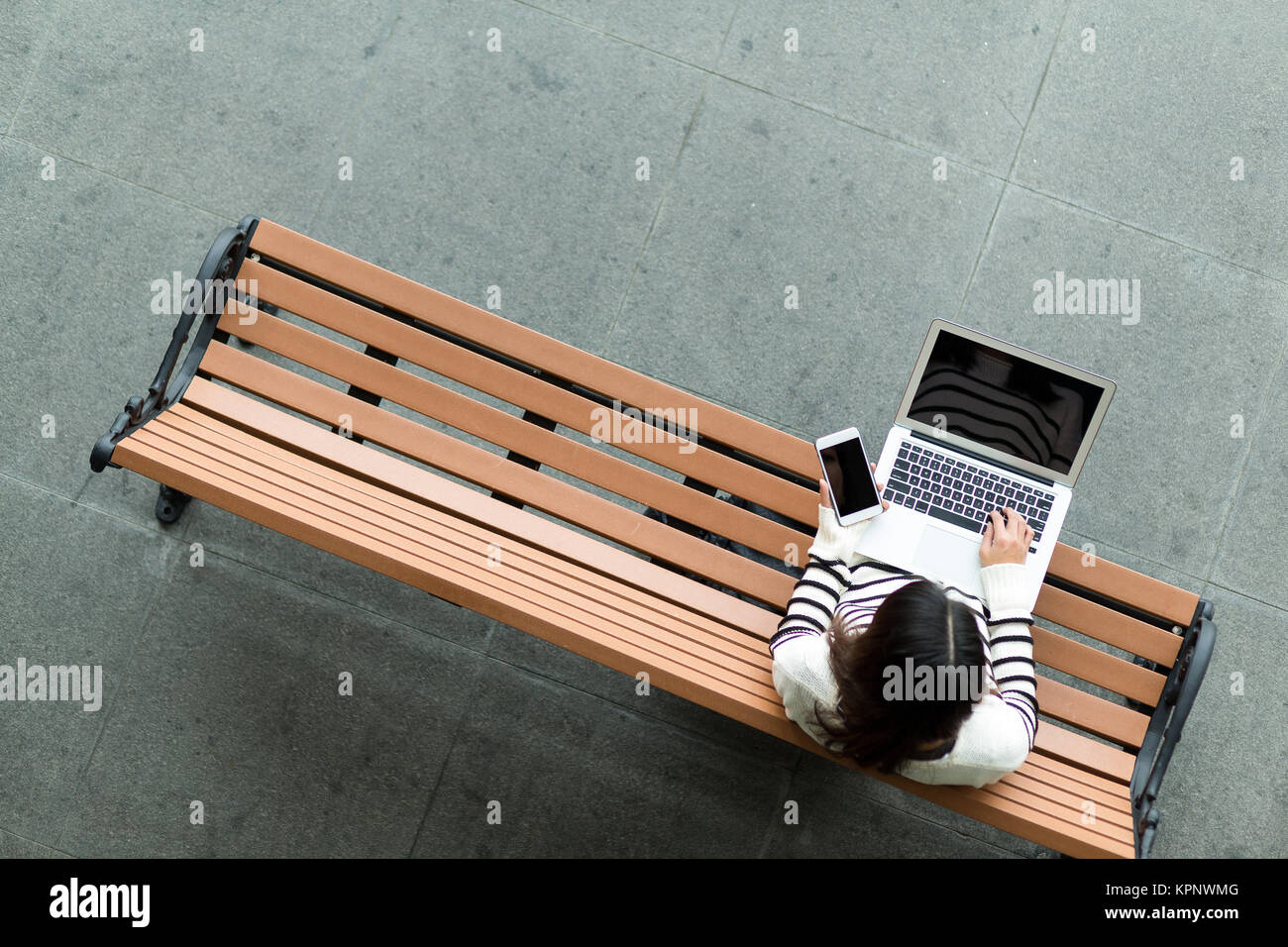 Top view of woman use of laptop computer and cellphone Stock Photo - Alamy