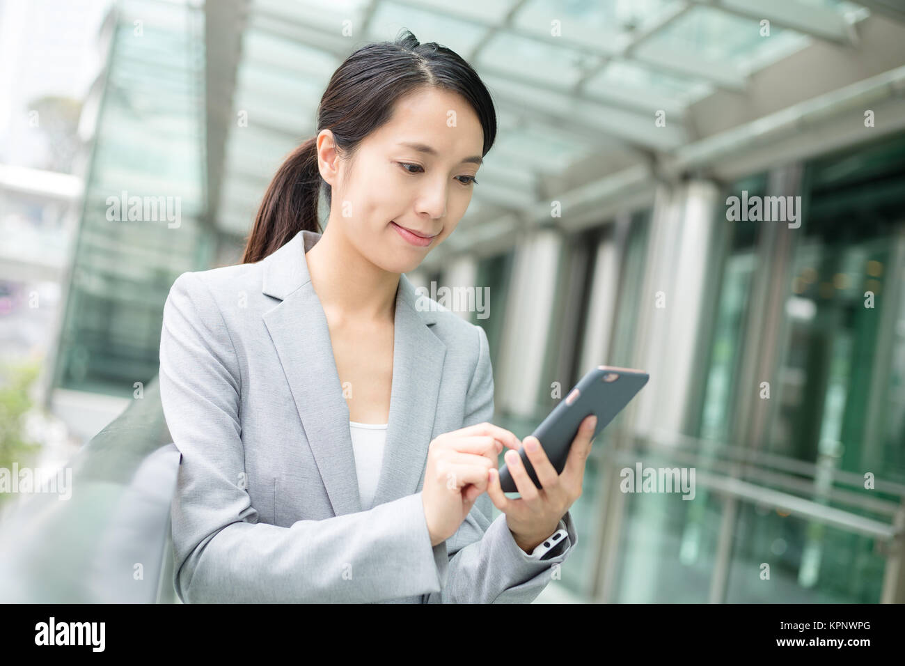 Business woman use of mobile phone Stock Photo - Alamy