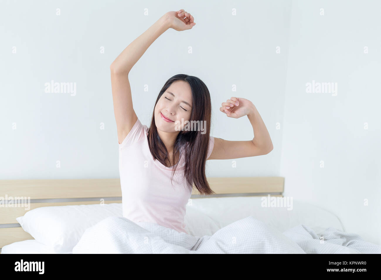 Woman Waking Up In Bed Stock Photo - Alamy