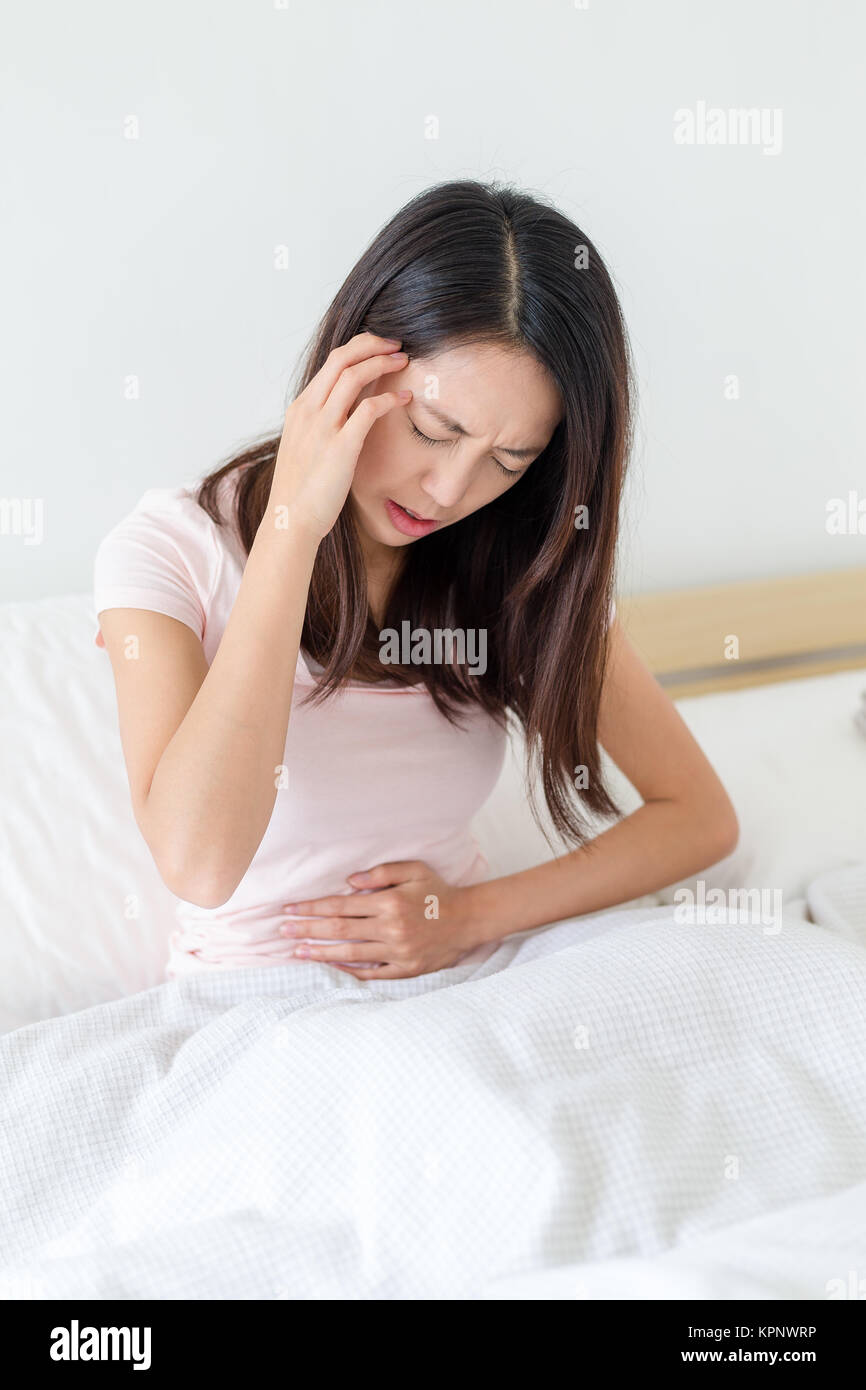 Woman got sick and take rest on bed Stock Photo - Alamy
