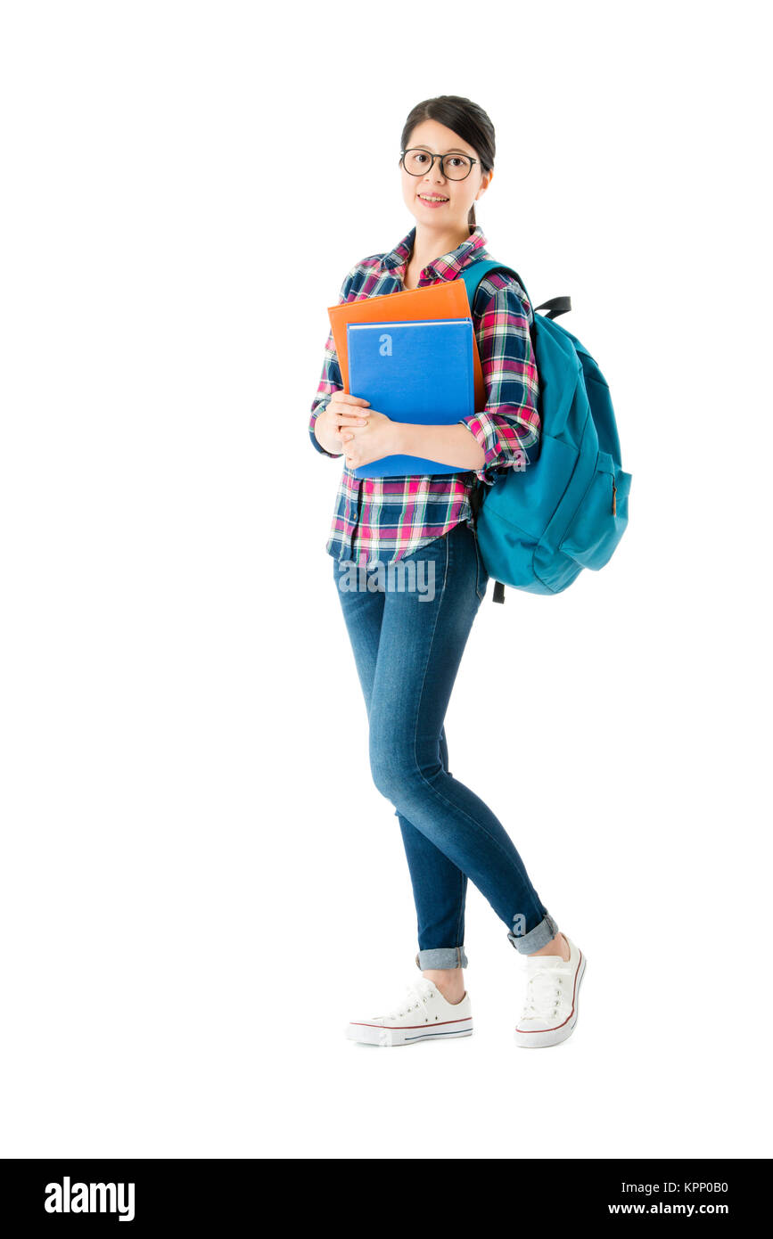 smiling attractive female student standing on white wall background ...