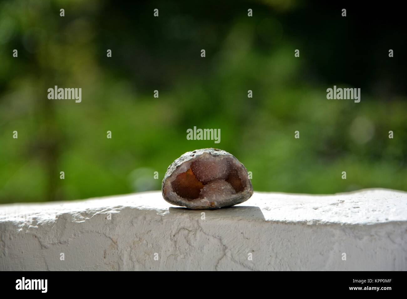 druse geode agate stone on white brick wall outdoors Stock Photo - Alamy